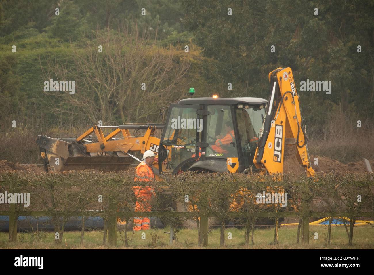The two workers with backhoe loader at the construction site Stock ...