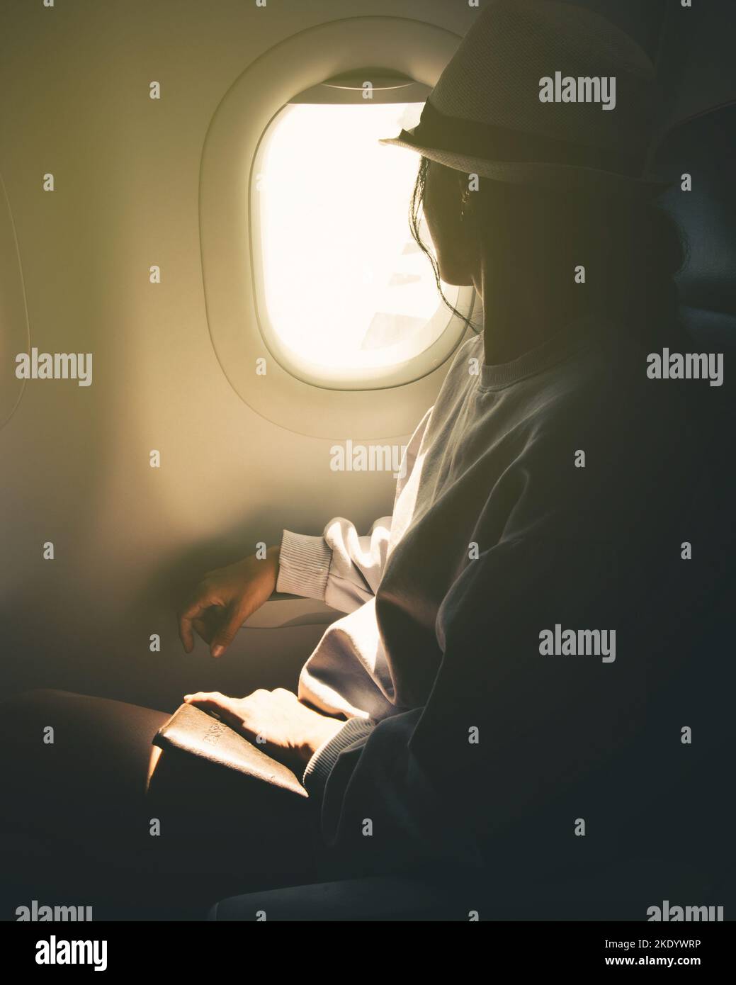 Close up silhouette of caucasian woman looks out the window of an ...
