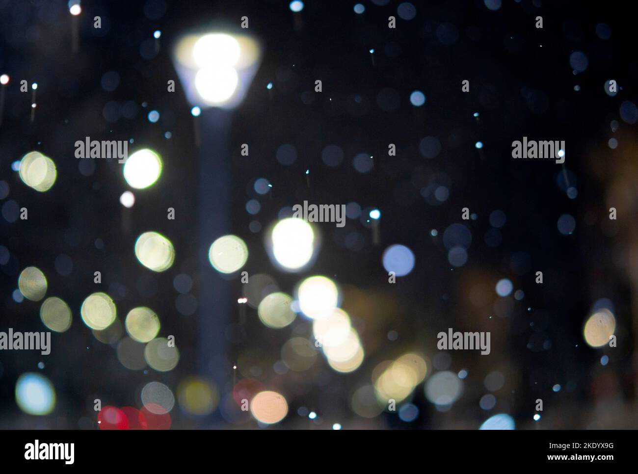 Blurred background. City view, lights, falling snow, night, street ...