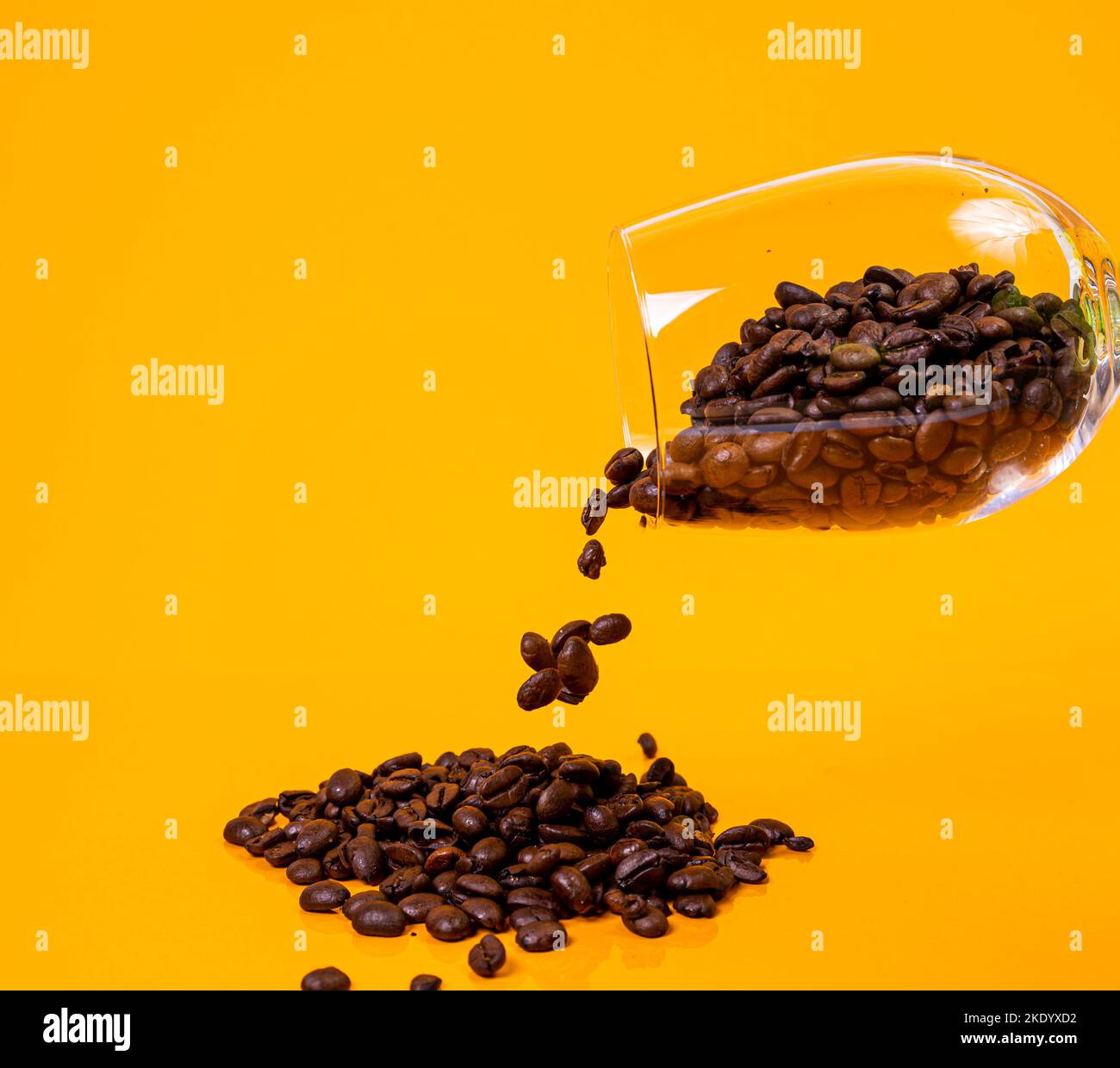 Dropped Many roasted coffee beans in a glass, in bucket jar. self ...