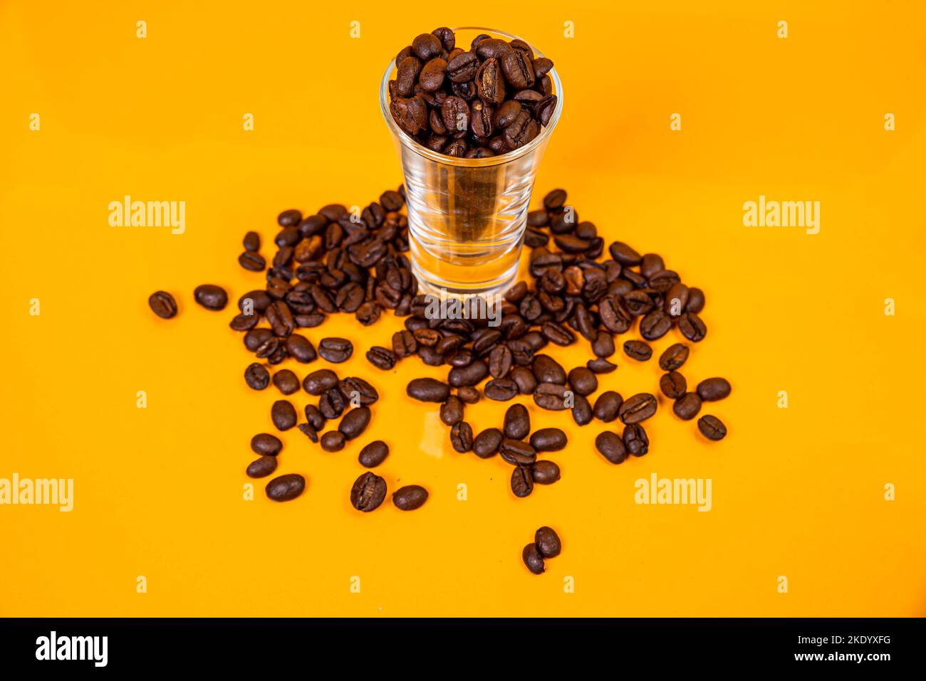 Dropped Many roasted coffee beans in a glass, in bucket jar. self ...