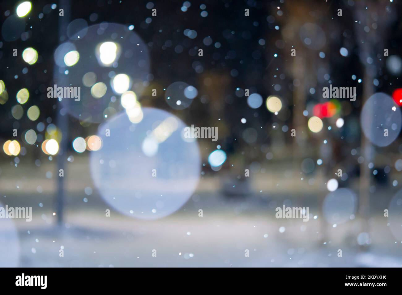 Blurred background. City view, lights, falling snow, night, street ...