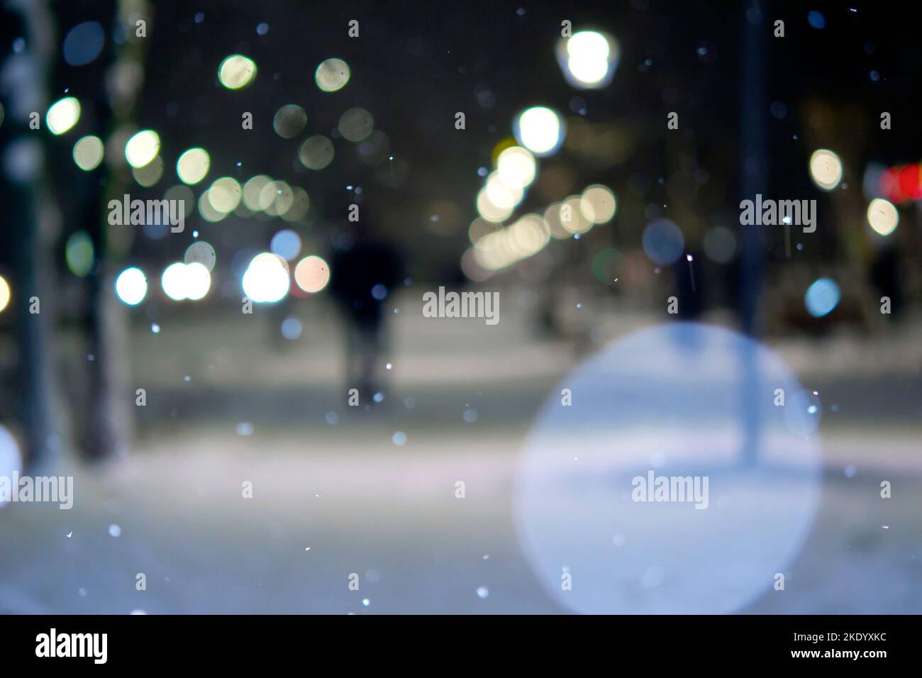 Blurred background. City view, lights, falling snow, night, street ...