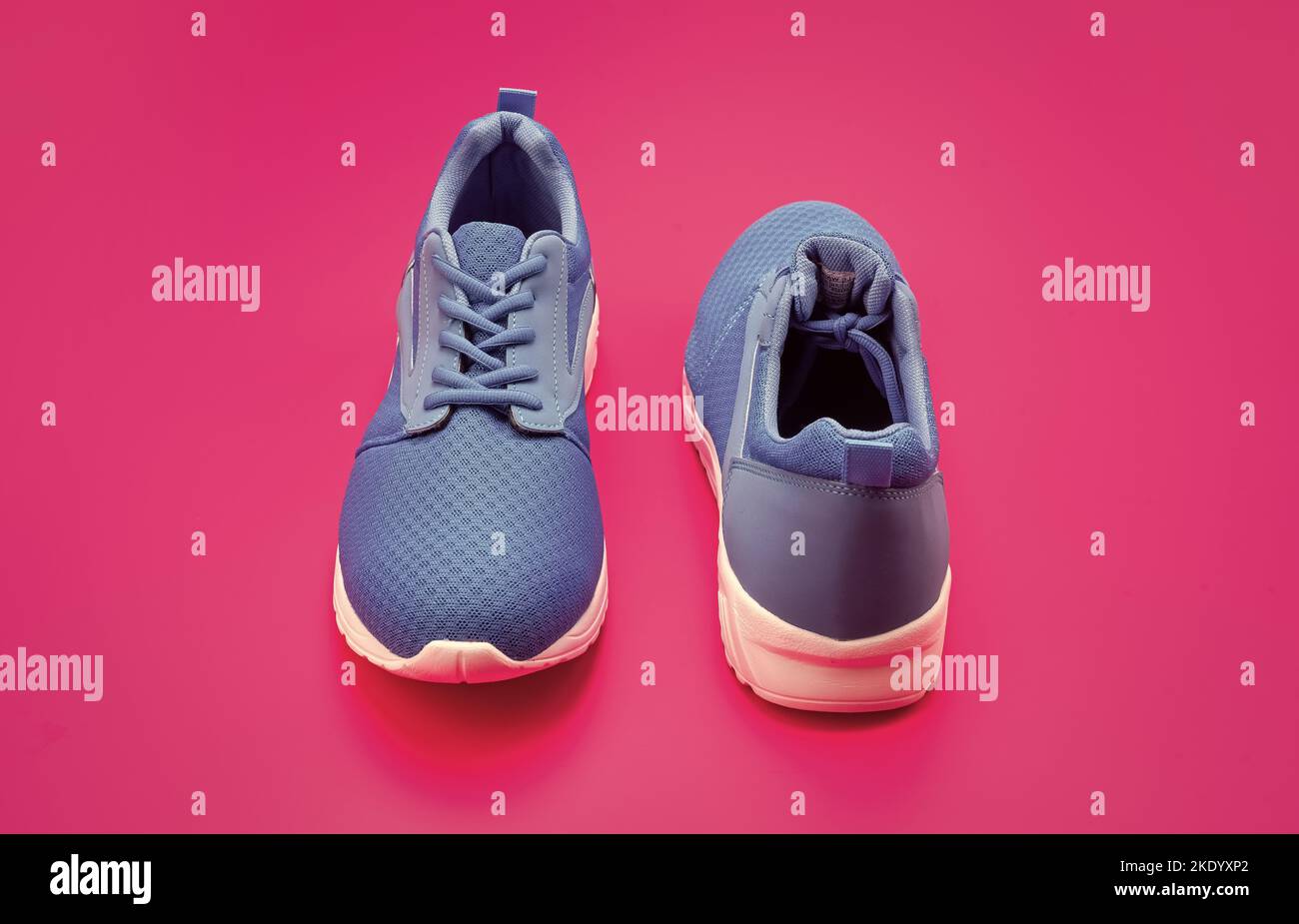pair of comfortable blue sport shoes on pink background, sneakers Stock ...