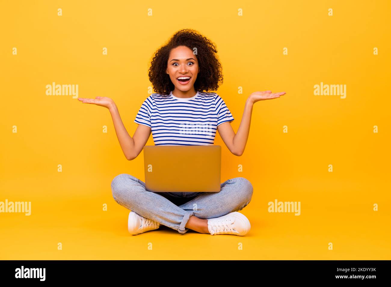Full body photo of excited attractive lady sit floor arms hold show ...