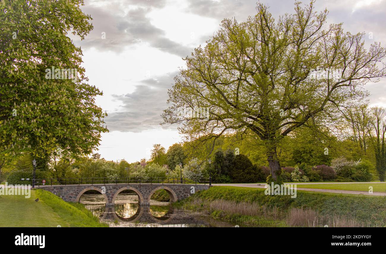 A mesmerizing shot of green trees, river, and the old, stone Vallo ...