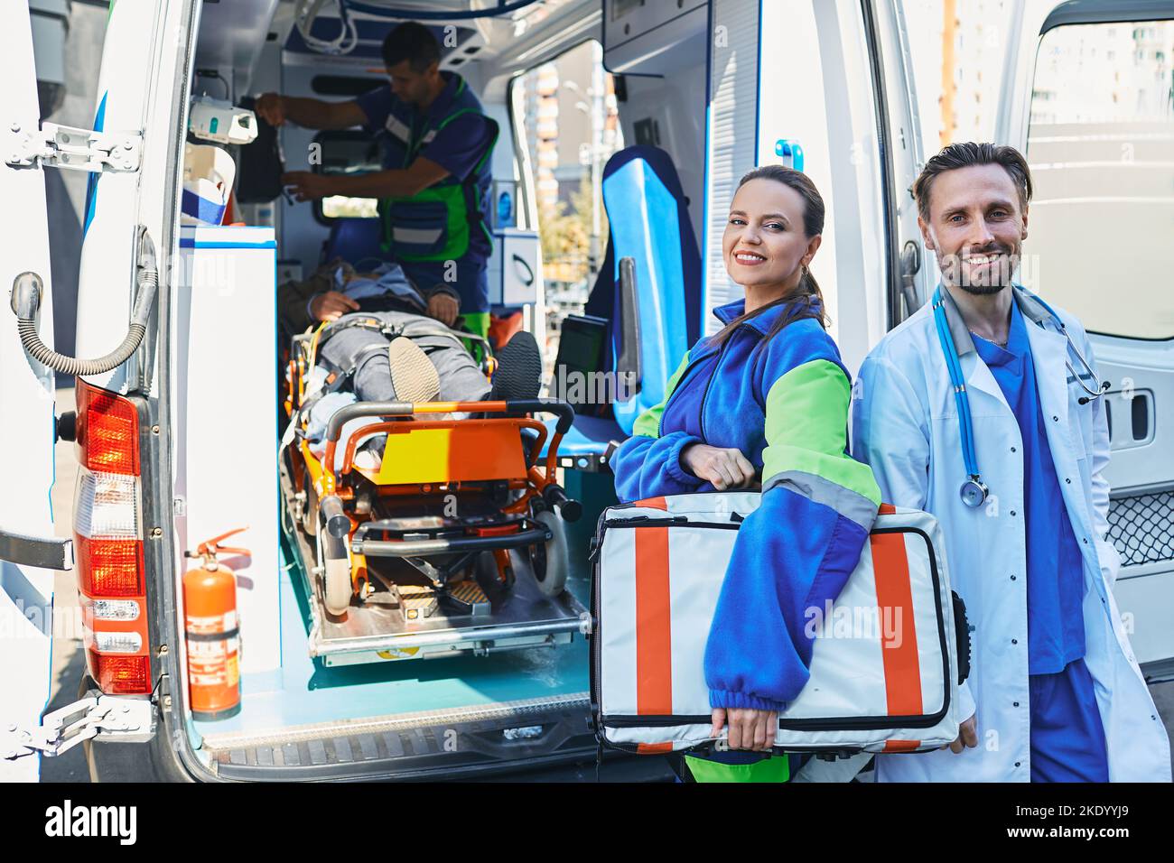 Portrait of beautiful paramedic woman and hospital doctor standing ...