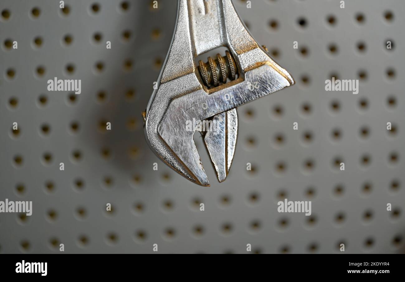 silver colored wrench hanging on tool board Stock Photo - Alamy