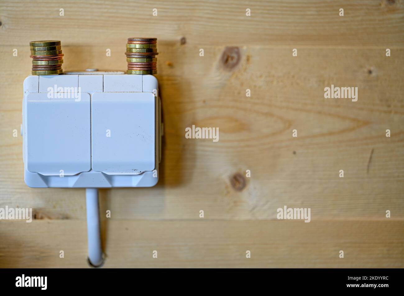 stacks of coins standing on electrical outlets in workshop Stock Photo ...
