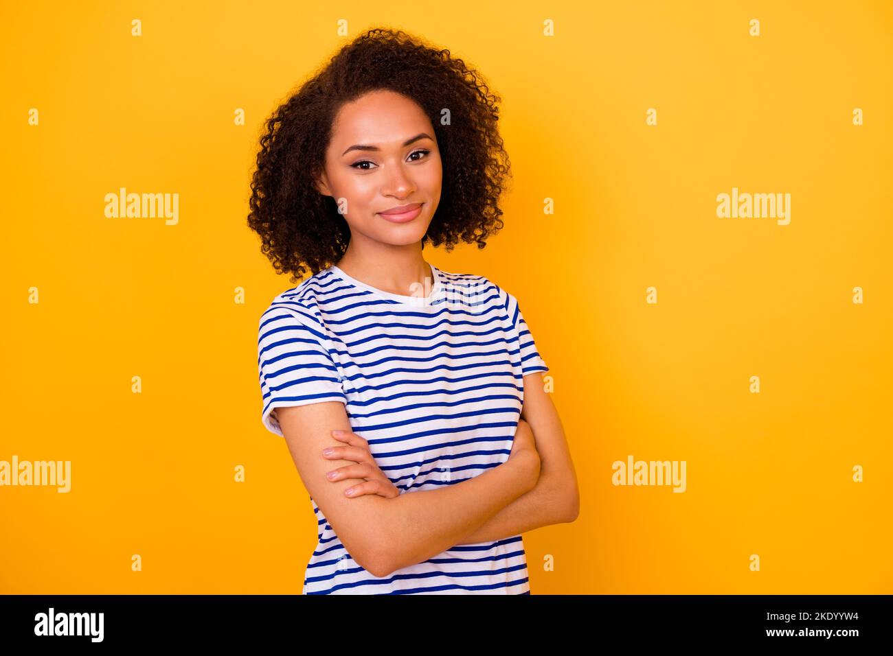 Portrait of cheerful charming girl crossed arms posing empty space ...