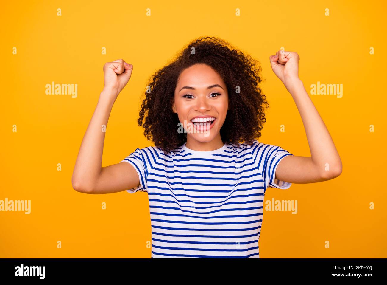 Photo of cheerful delighted girl raise fists triumph attainment toothy ...