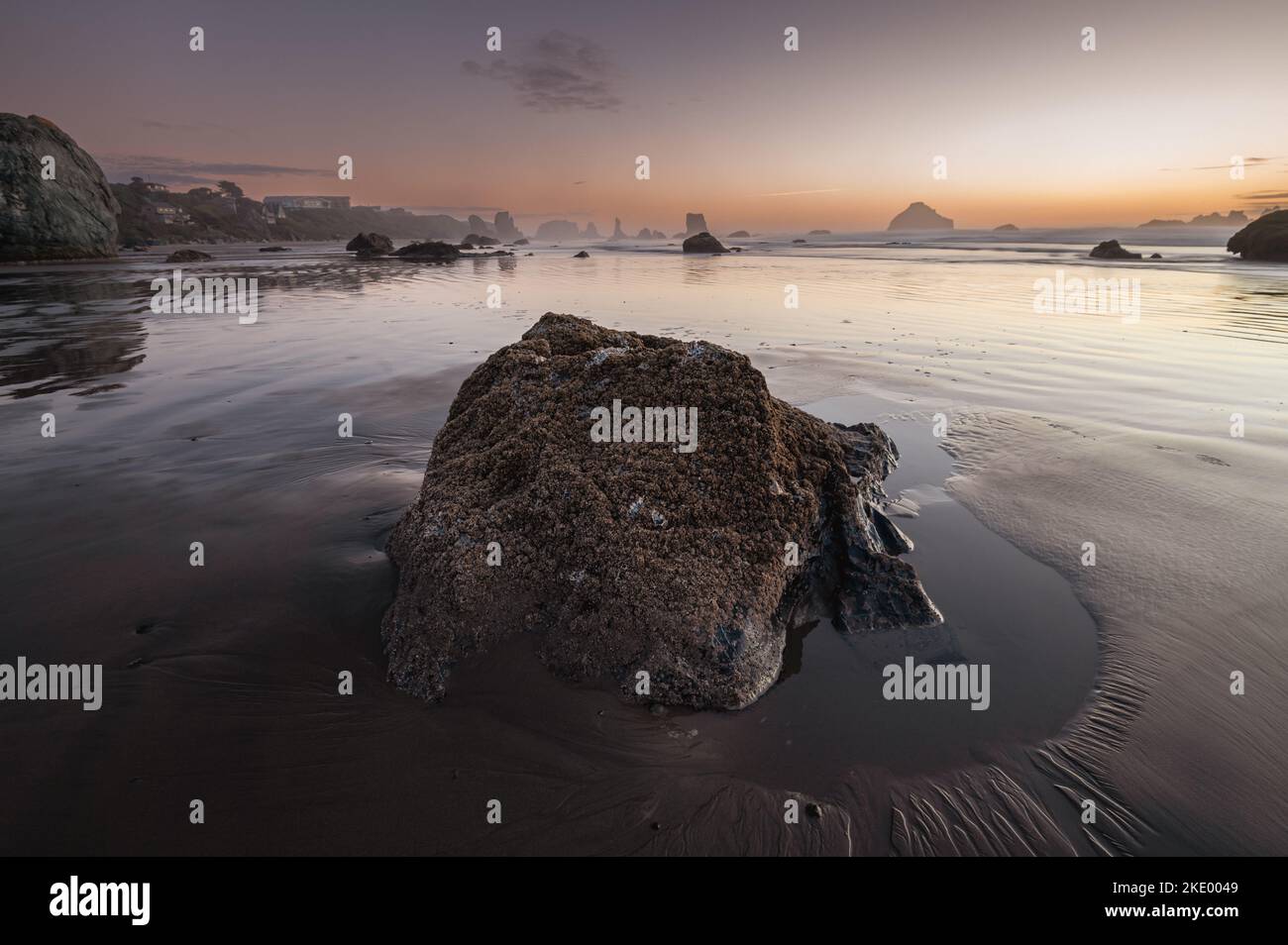 Oregon Coast sunset rock on beach Stock Photo - Alamy