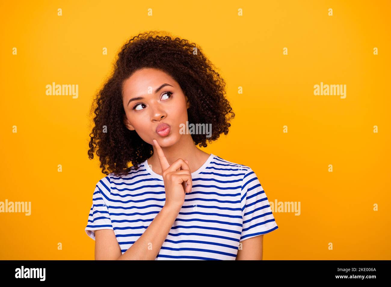 Photo of minded creative lady finger touch chin pouted lips look empty ...