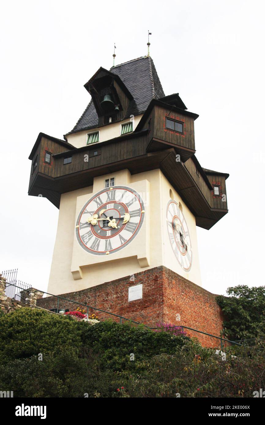 A Uhrturm historical landmark building with clocks by it sides Stock ...