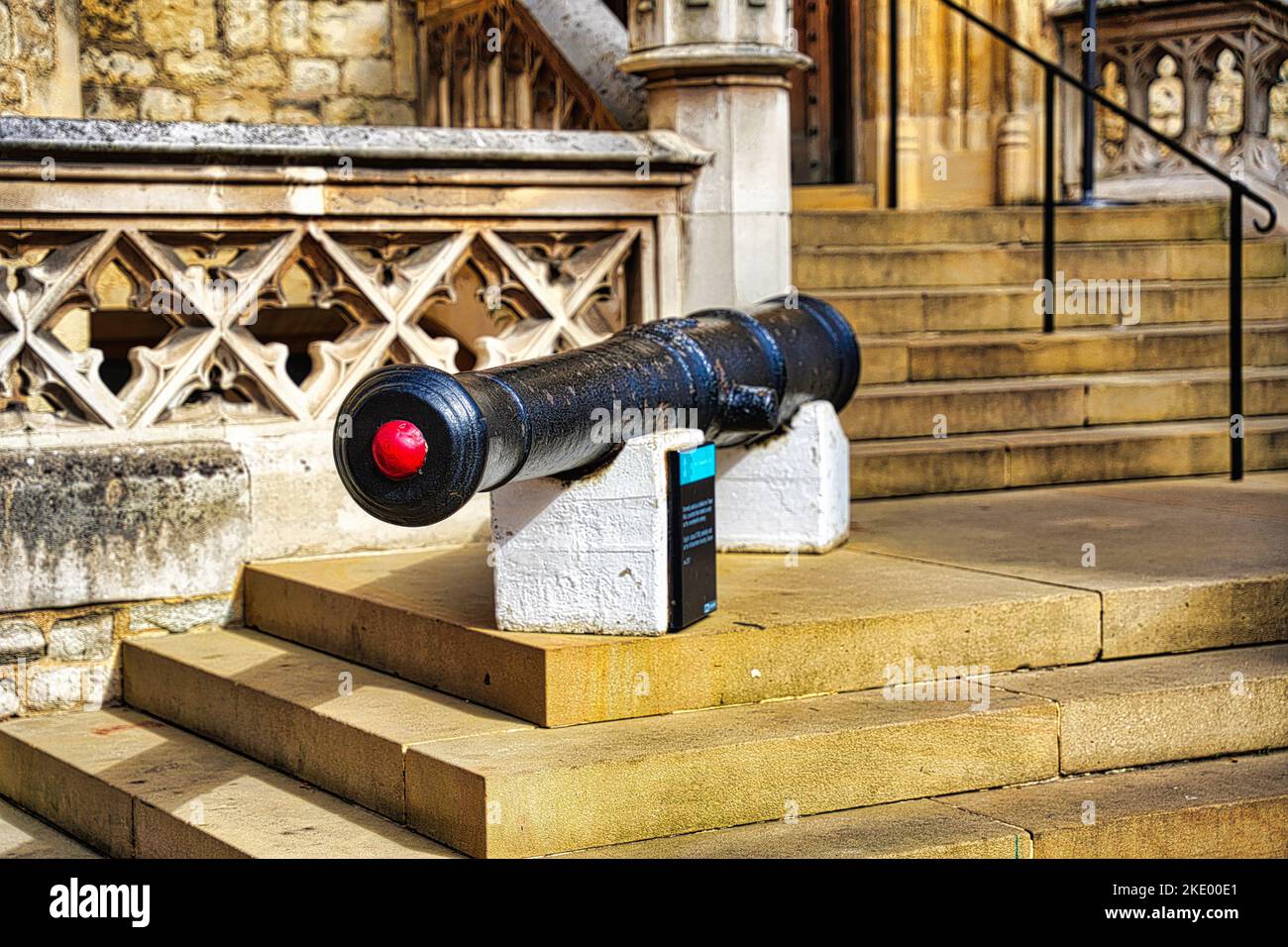 A museum exhibit of a historic steel cannon barrel displayed on two ...