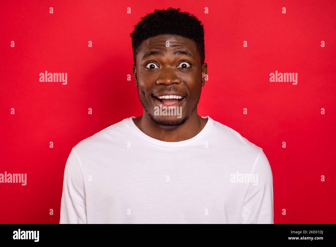 Photo of cheerful person toothy smile stare speechless isolated on red ...