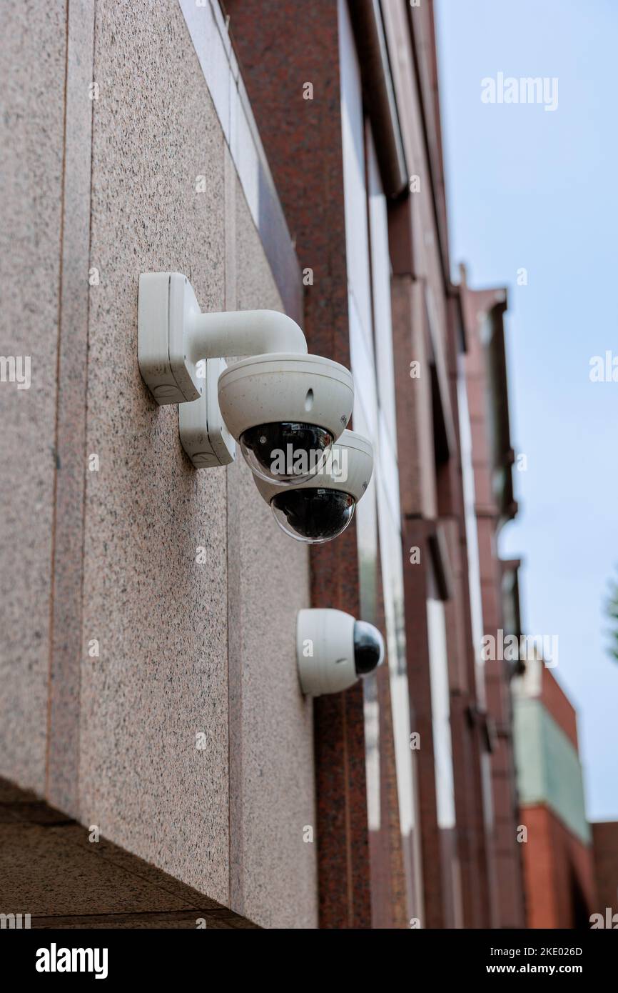 A vertical shot of security cameras on the side of a building Stock ...