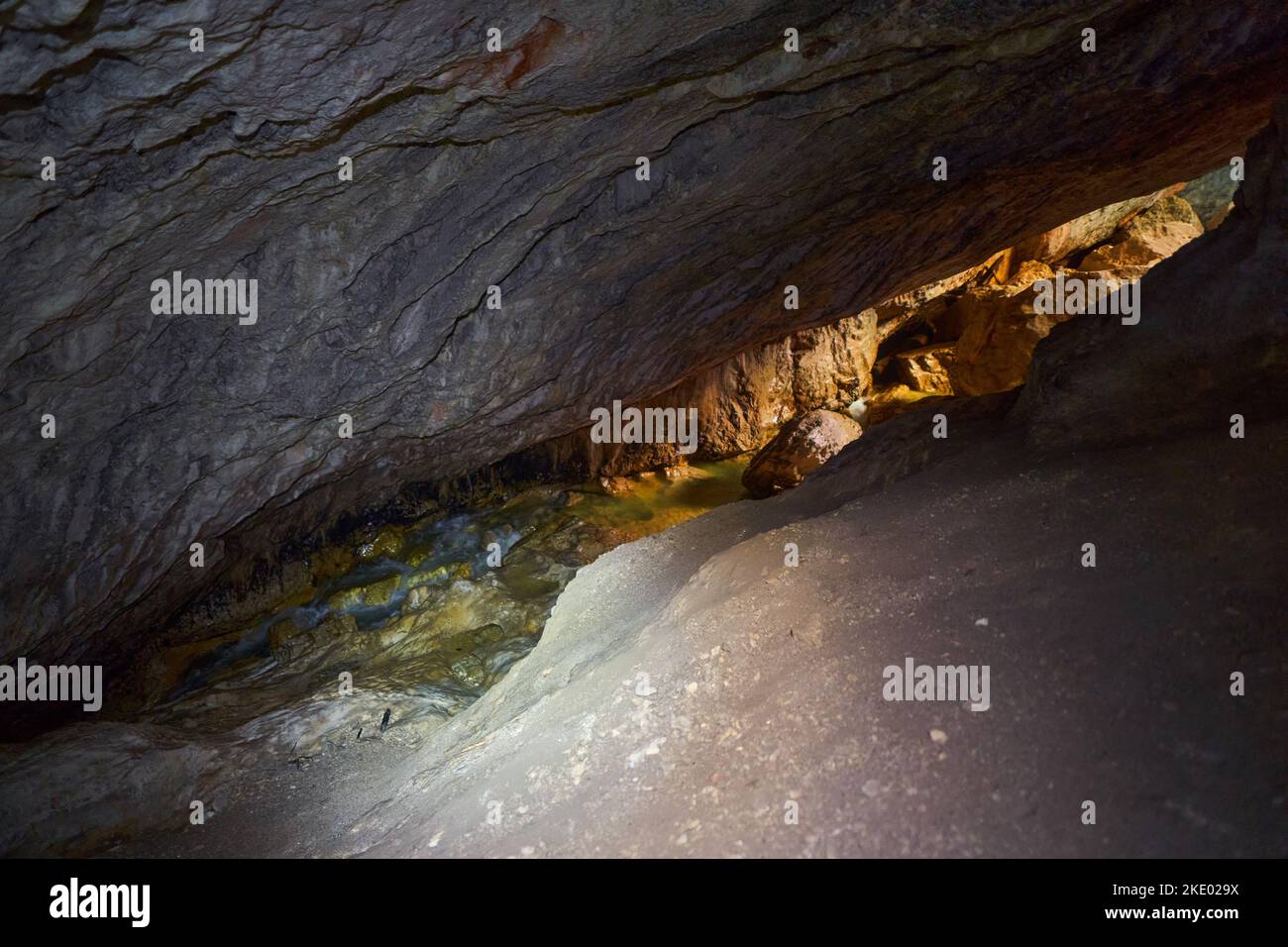 Cave entrance with an underground river in it's depth Stock Photo - Alamy