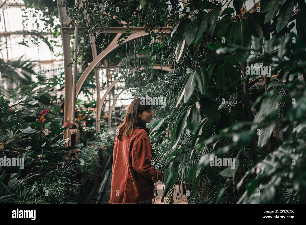 young caucasian woman with long hair and brown jacket among the ...