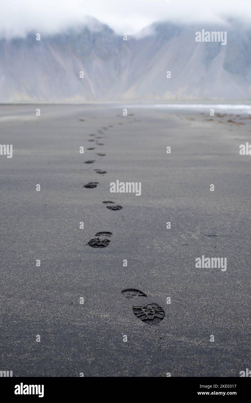 A vertical shot of the Foot Steps on Stockness Beach in Iceland with ...