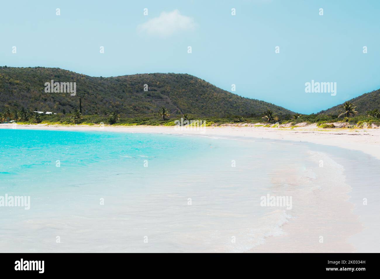 The beautiful Flamenco beach with forested hills and tropical trees on ...