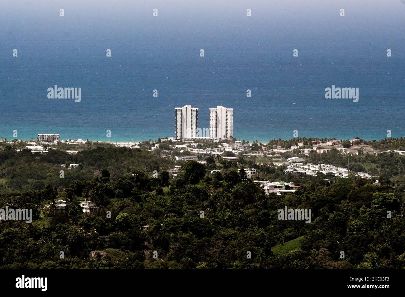 The El Yunque National Forest with a scenic blue beach and white tall ...