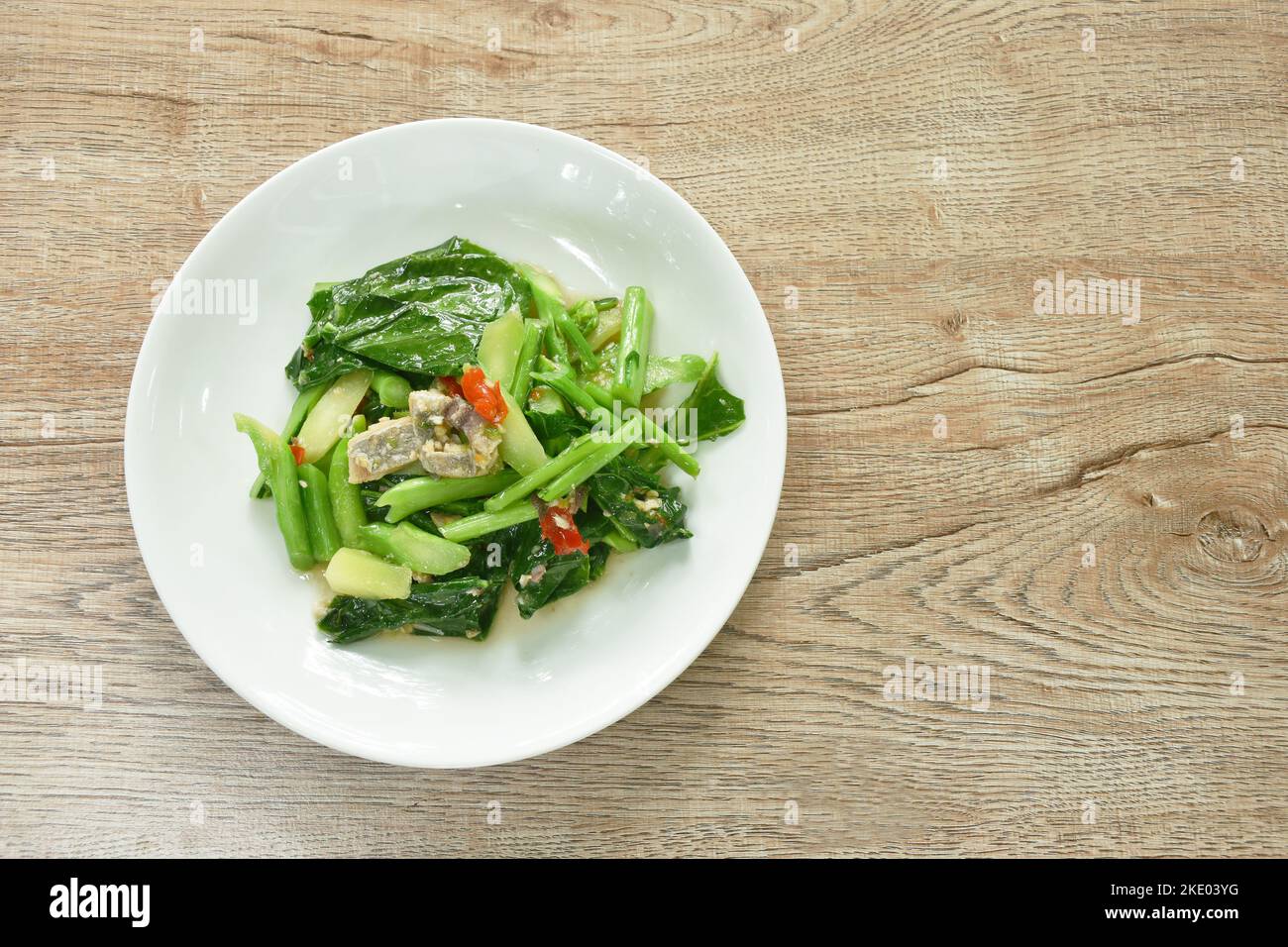 fried Chinese kale with chop salty fish in oyster sauce on plate Stock ...