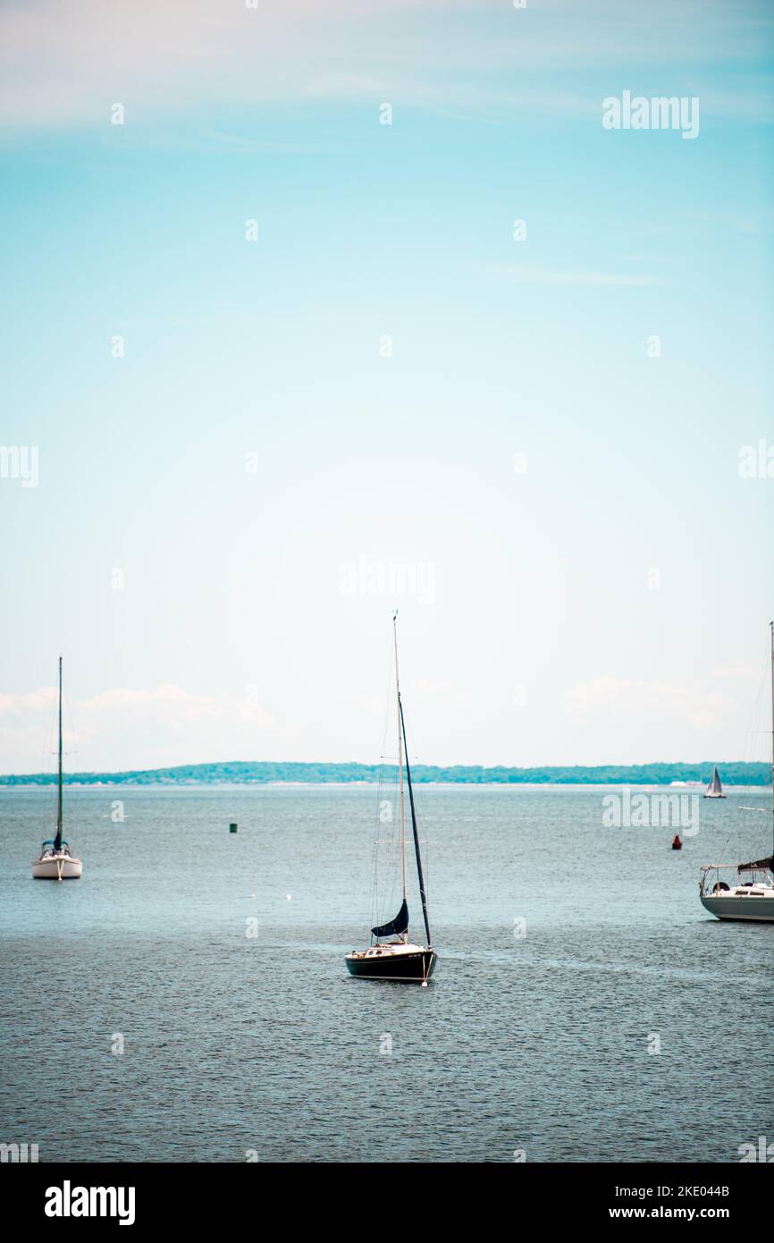 A vertical high-angle of boats sailing on the sea skyline background ...