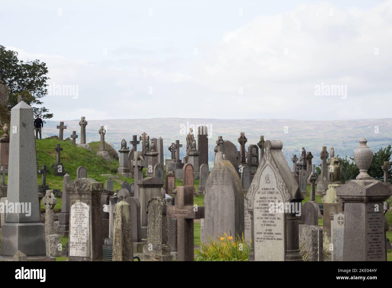A closeup of old stone graves on a grassy land in a cemetery Stock ...