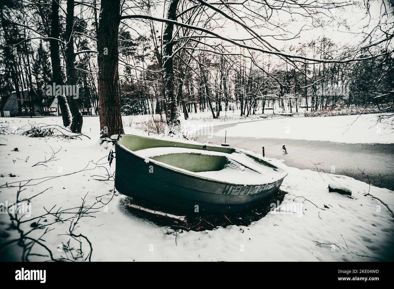 A frozen boat in a forest with trees covered with snow Stock Photo - Alamy