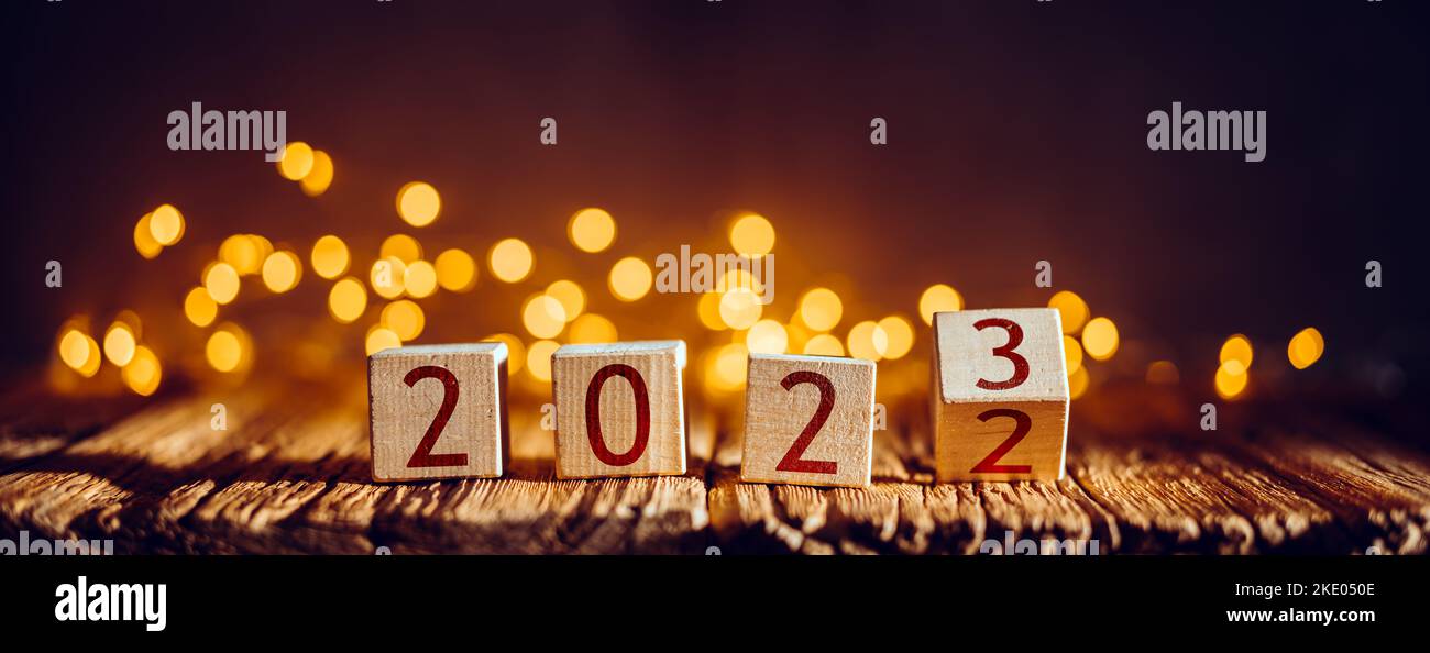 Wooden cubes changing calendar date from 2022 to 2023. New year coming ...