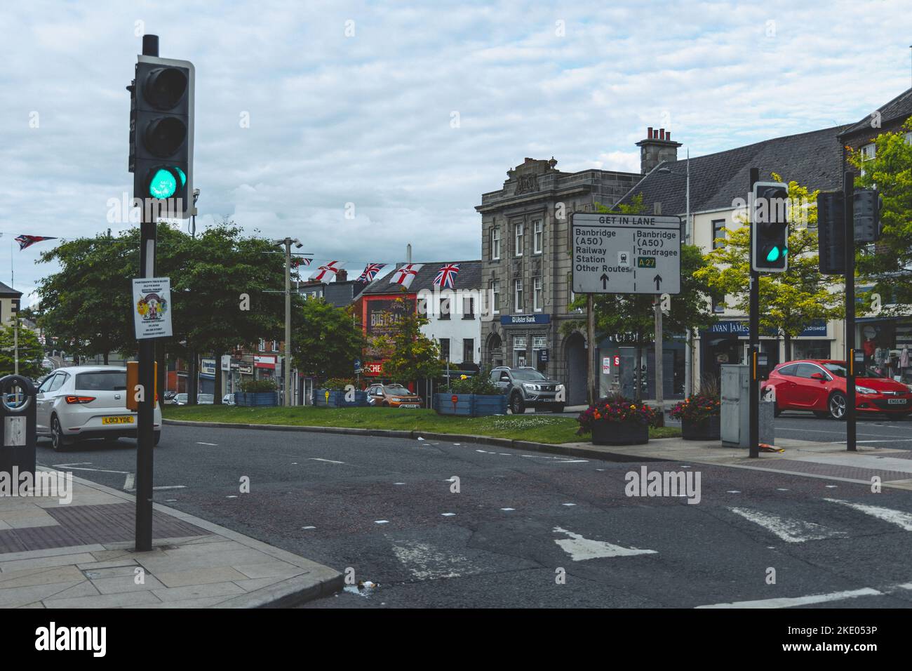 A street view with cars, traffic lights, architectures and tree in ...