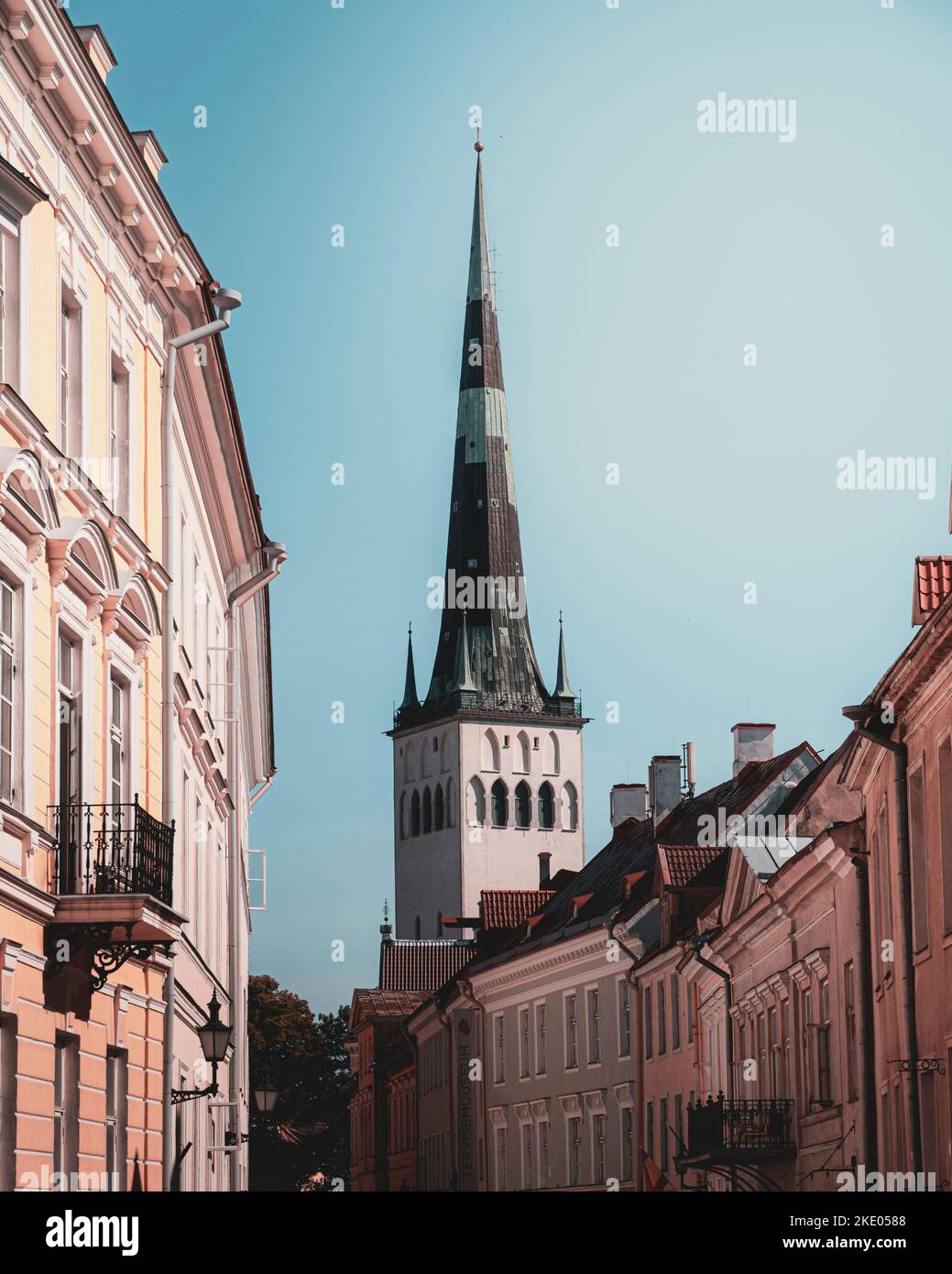 A vertical shot of cathedral's tower behind buildings in the old town ...