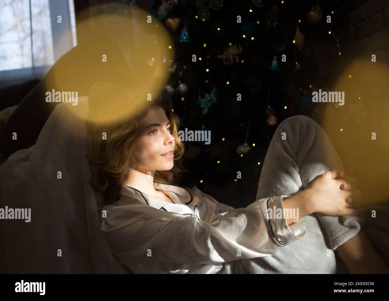 cute girl aged 16-18 in white, highlighted with light on the background ...
