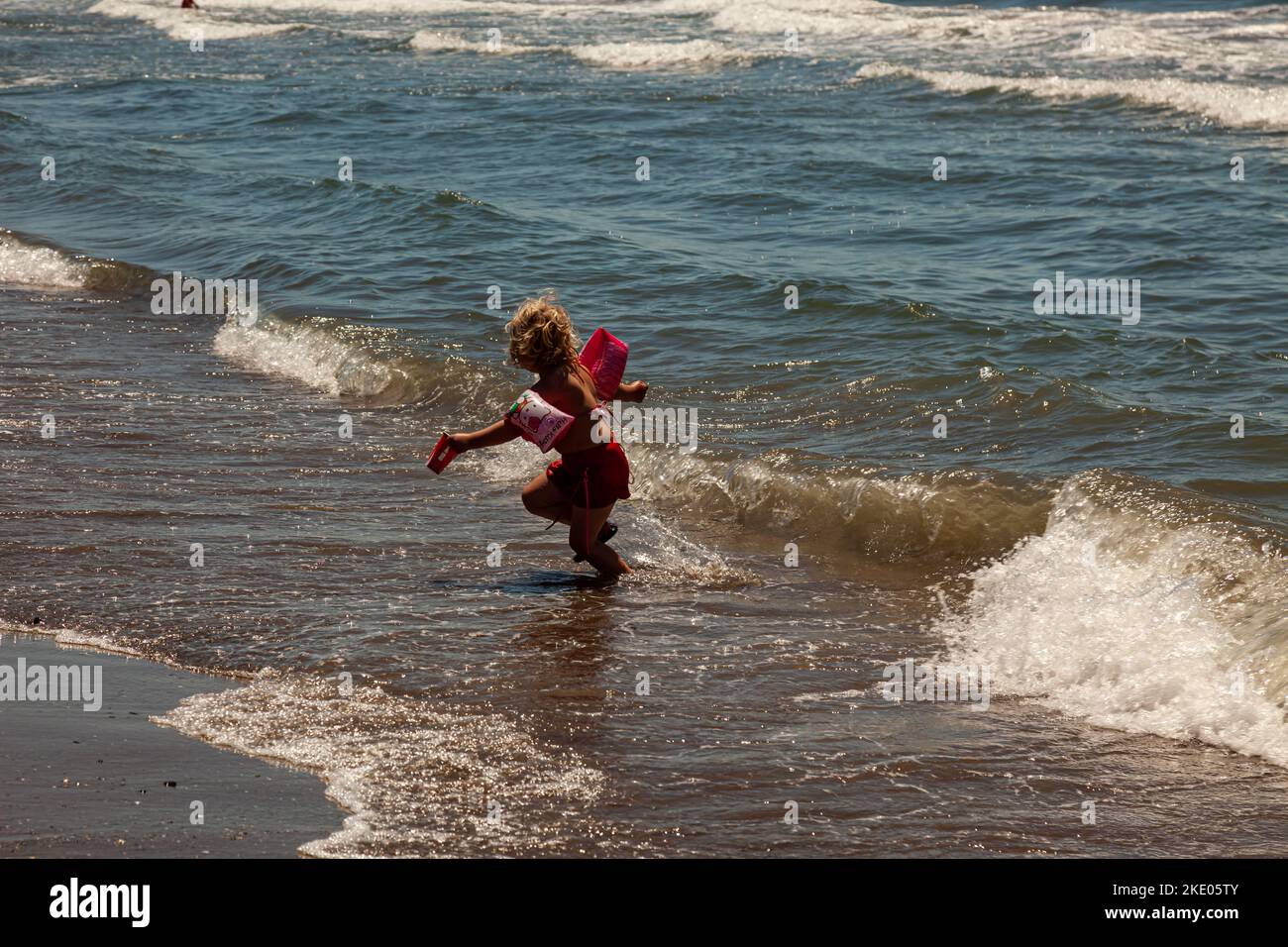 Girl running from waves hi-res stock photography and images - Alamy