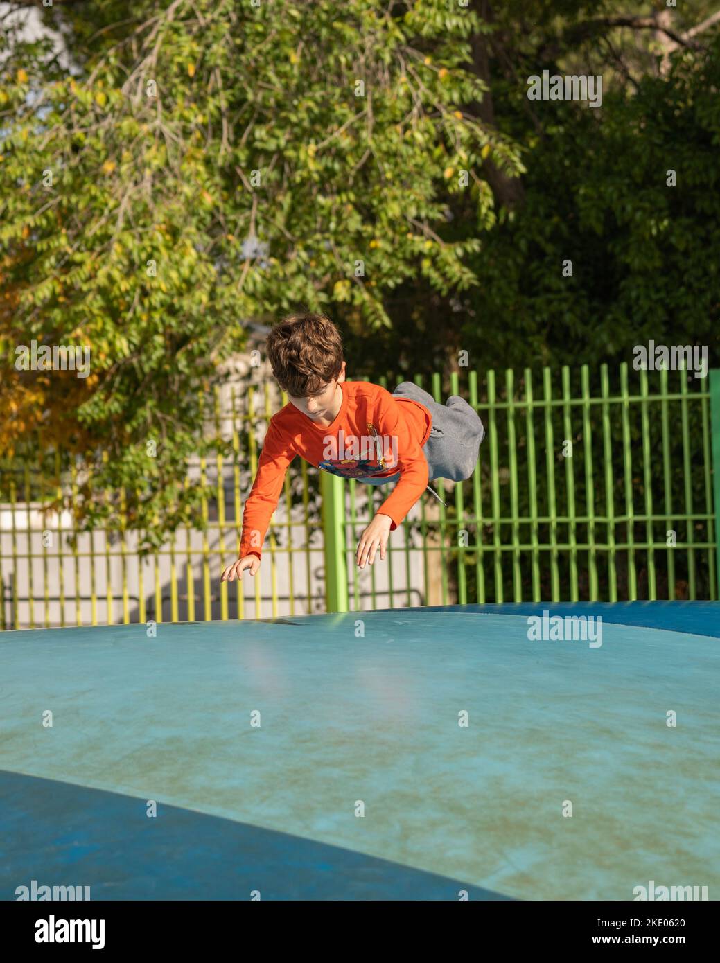 Child bouncing on playground hi-res stock photography and images - Alamy