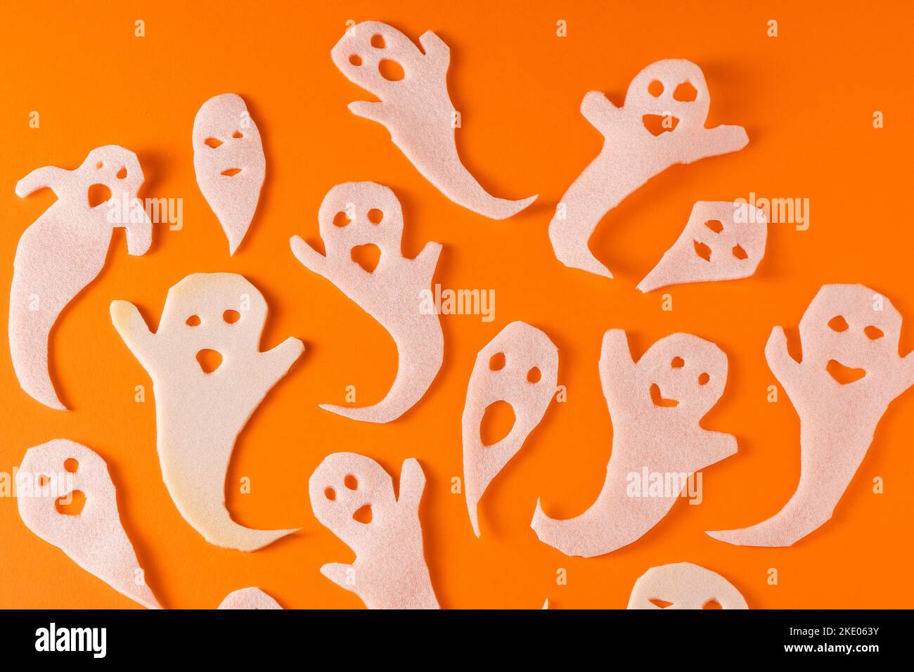 White ghosts kids craft for Halloween. Wrapping paper ghost on orange ...