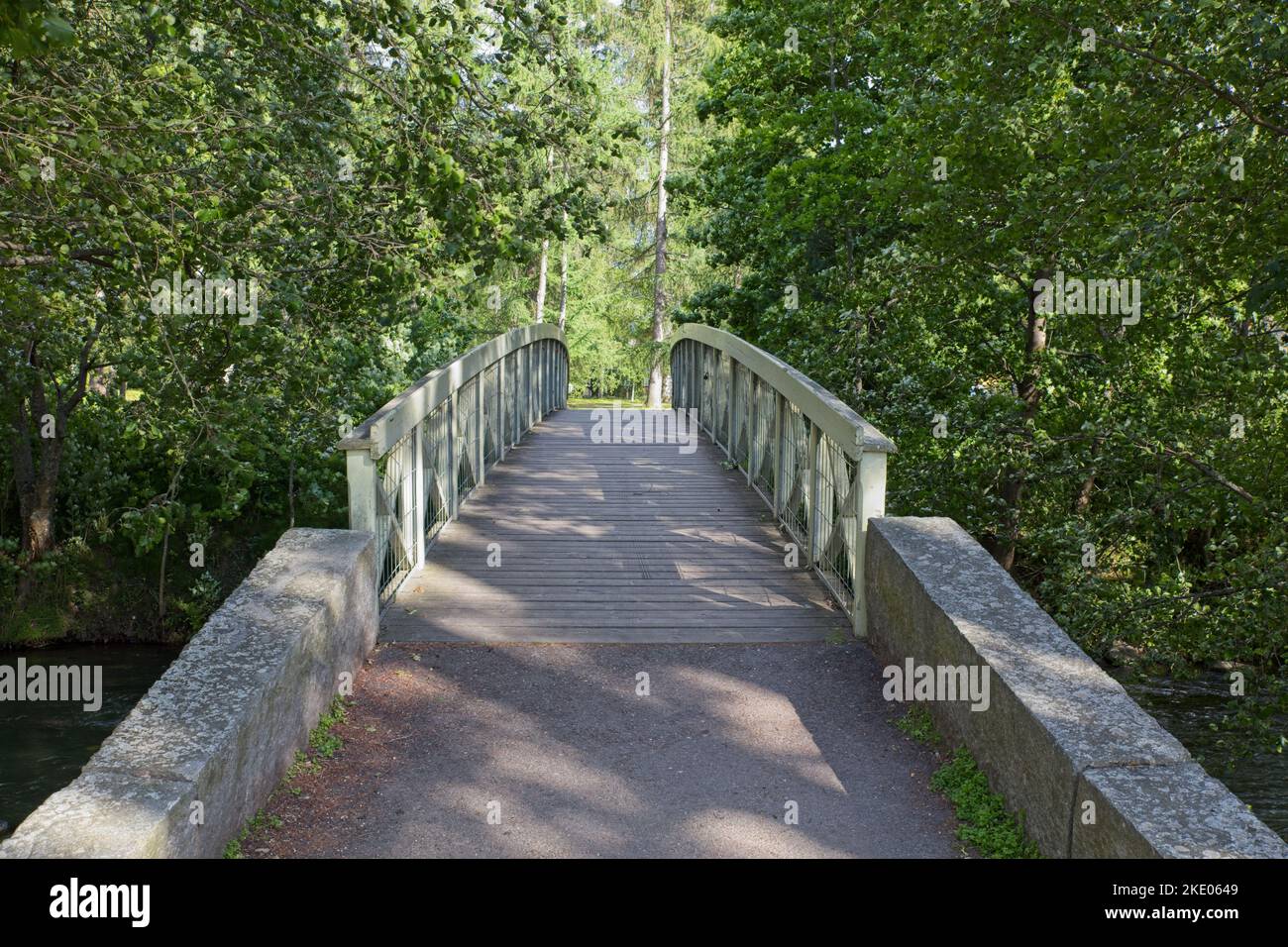 Small wooden walking bridge over Vääksyjoki river with wooden handrails ...