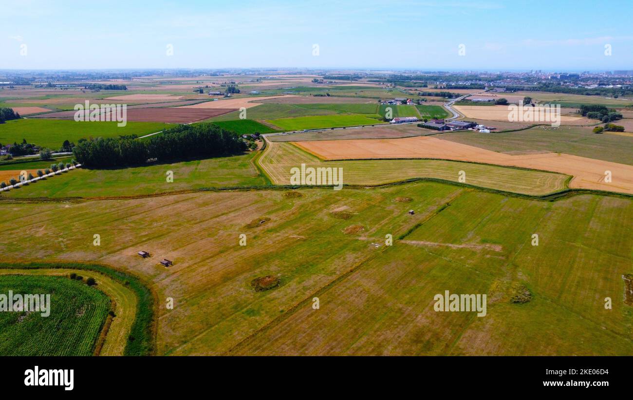 An aerial shot of a green agricultural landscape with a clear blue ...