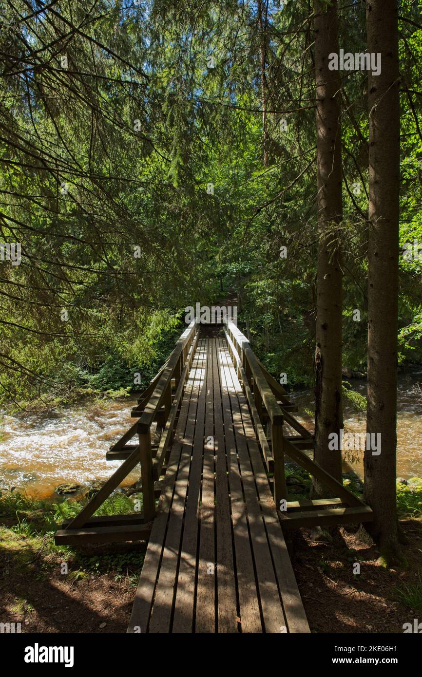 Wooden bridge over rapids of Nukarinkoski with rocks in stream in ...