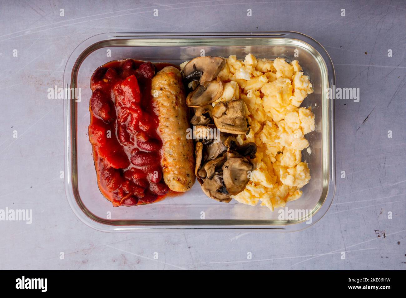 A closeup shot of omelette with sausage and mushrooms in a glass bowl ...