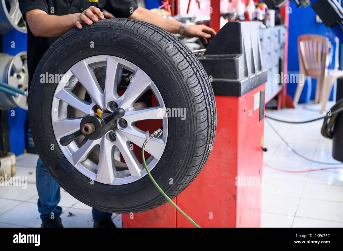 A mechanic replacing a tire on rim by machine Stock Photo - Alamy