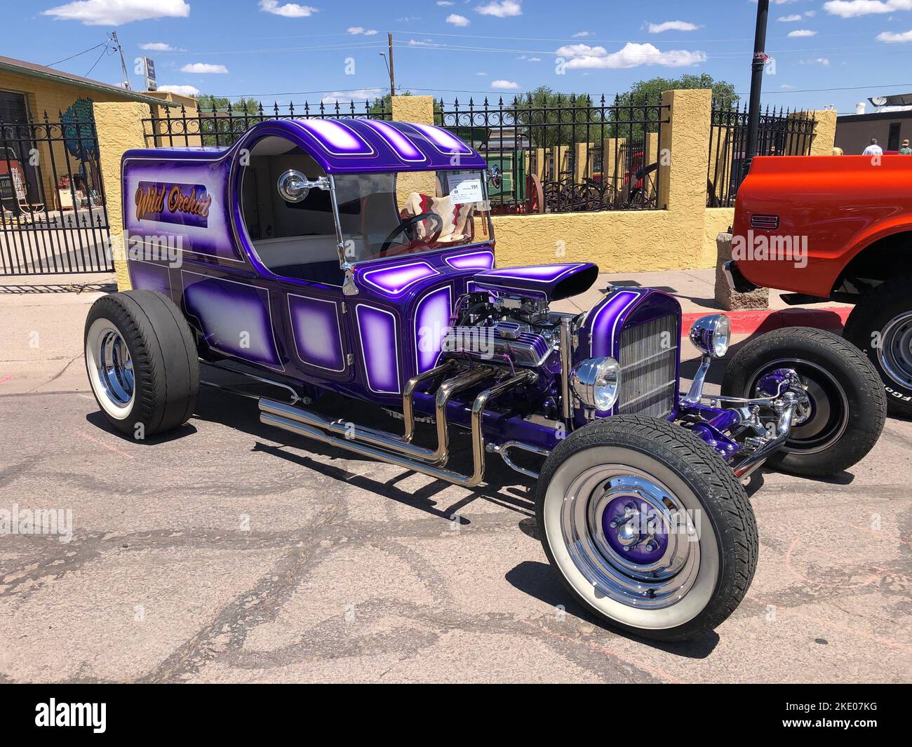 A beautiful vintage purple Ford 32 hot rod on the road during a car ...