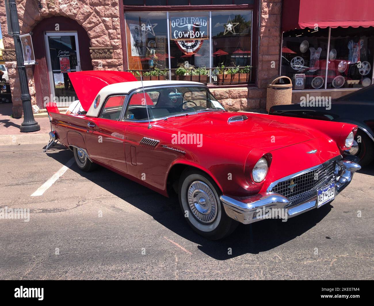 A beautiful classic red Ford Thunderbird on the road during a car show ...