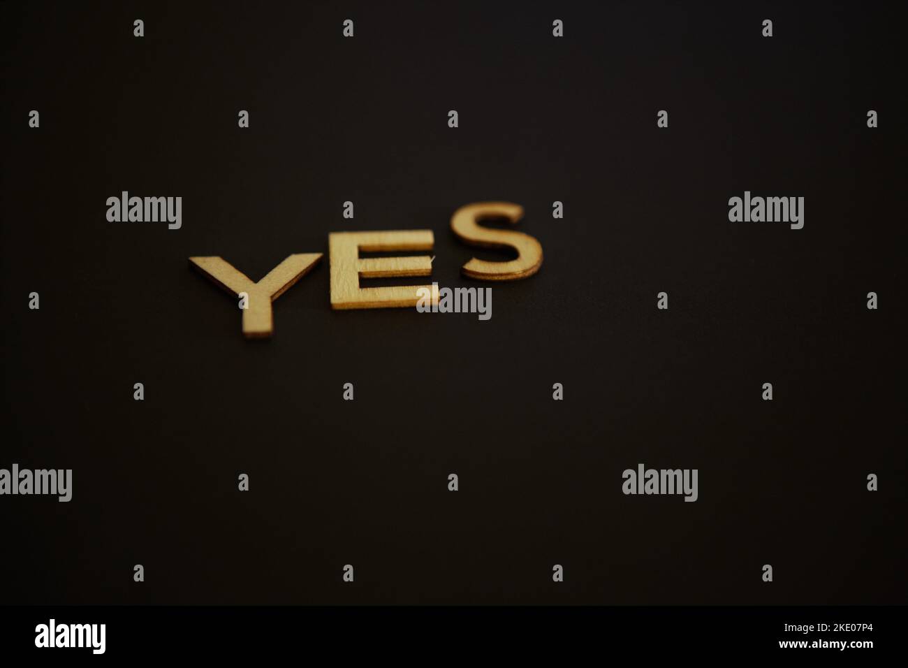 A bright yes text on a dark black background Stock Photo - Alamy