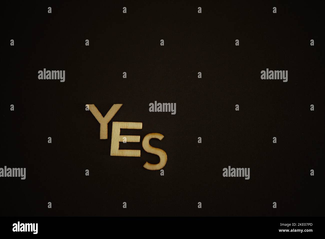 A bright yes text on a dark black background Stock Photo - Alamy