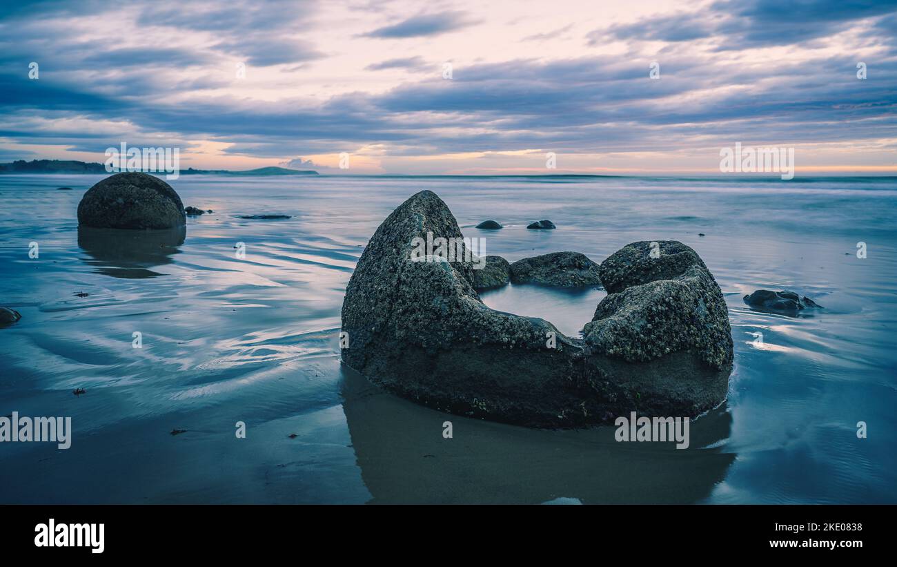 A scenic view of Moeraki Boulders Beach in Hampden, New Zealand at ...