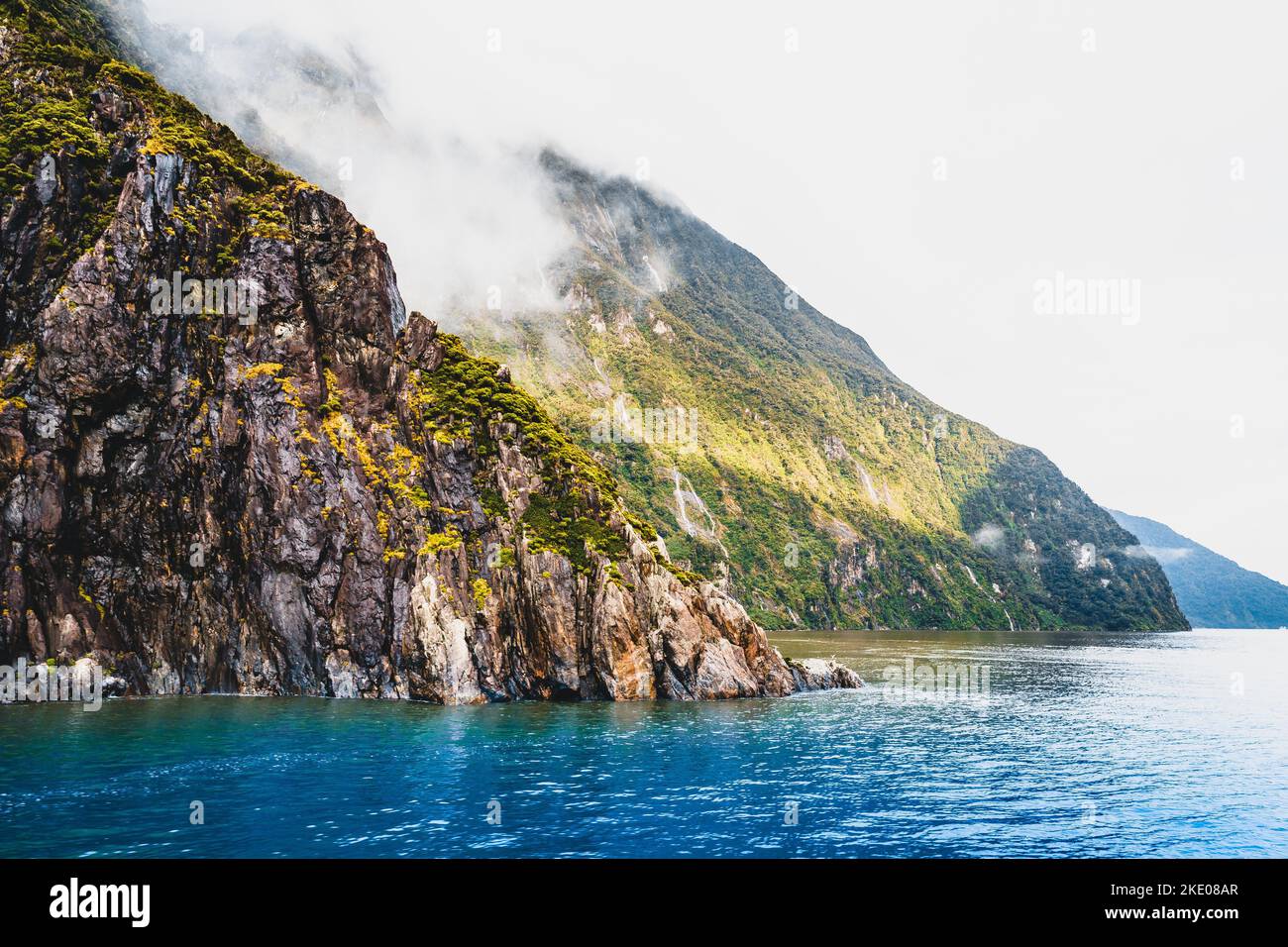 An aerial view of lake surrounded by rocky greenery mountains Stock ...