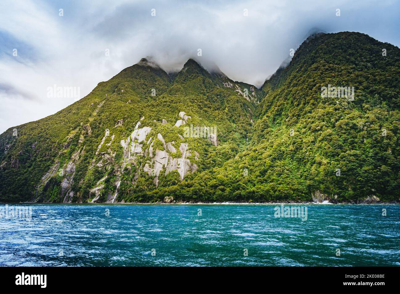 An aerial view of lake surrounded by rocky greenery mountains Stock ...