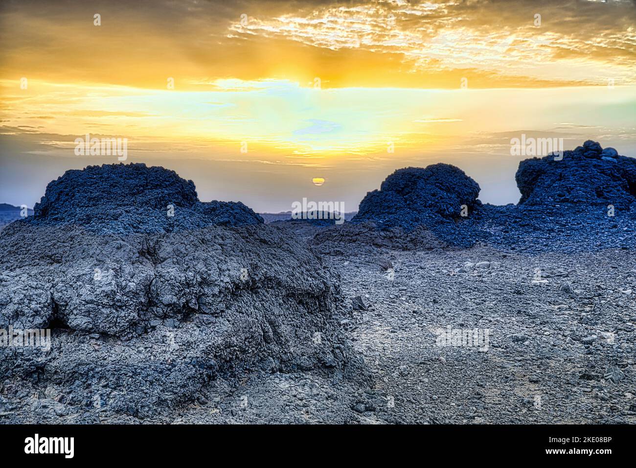 The view of a desert landscape under the golden sunset sky in Saudi ...